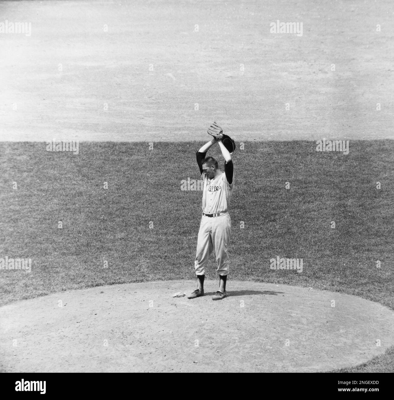 Jim Bunning (14) of the Philadelphia Phillies wipes sweat from his face ...