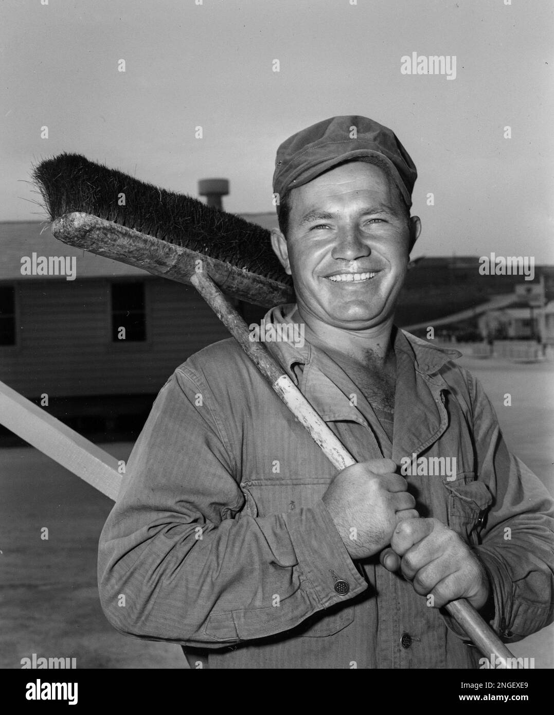 Former baseball player Lou Novikoff poses with a broom at the Fort ...