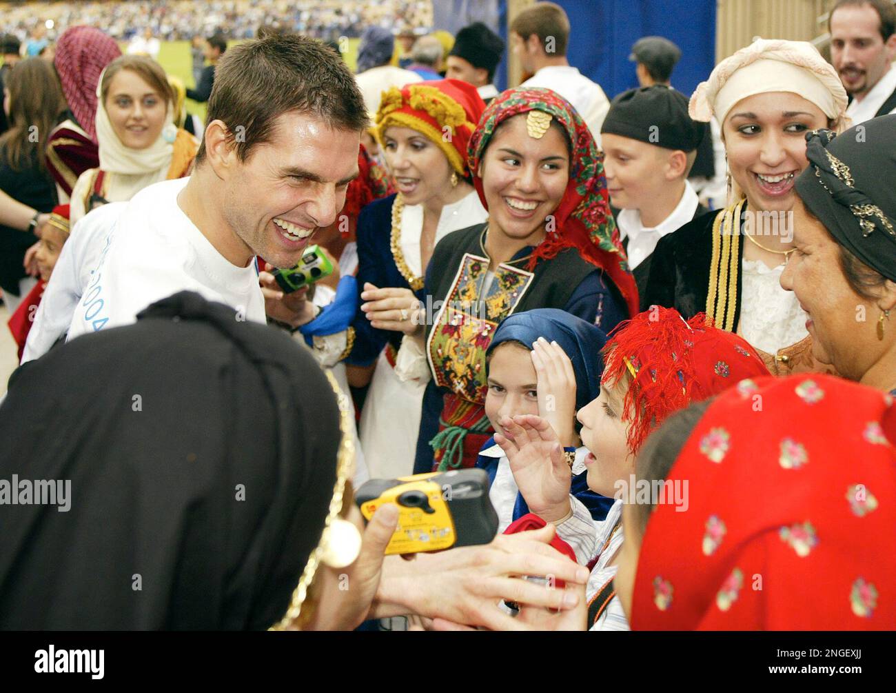 Actor Tom Cruise greets performers before running inside Dodger Stadium ...