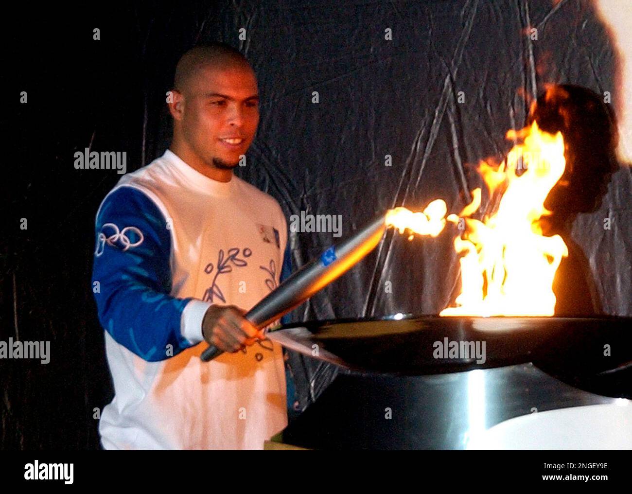 Brazilian soccer star Ronaldo lights the Olympic Torch in Rio de ...