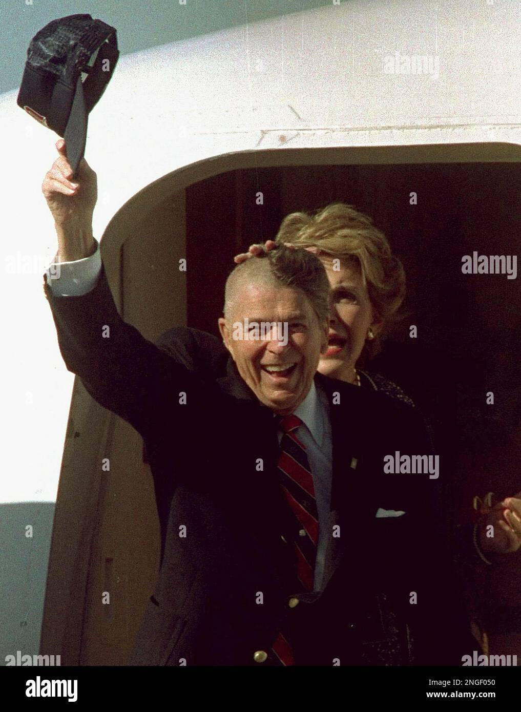 Former President Ronald Reagan doffs his baseball cap, exposing his ...