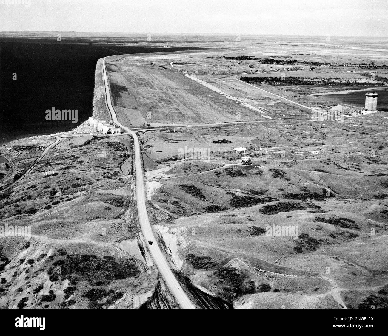 This aerial view shows the completed Fort Peck Dam, the first of the U ...