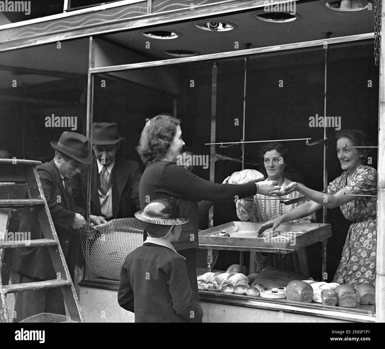 Bread is sold at this bakers, through the remains of the window, whilst ...