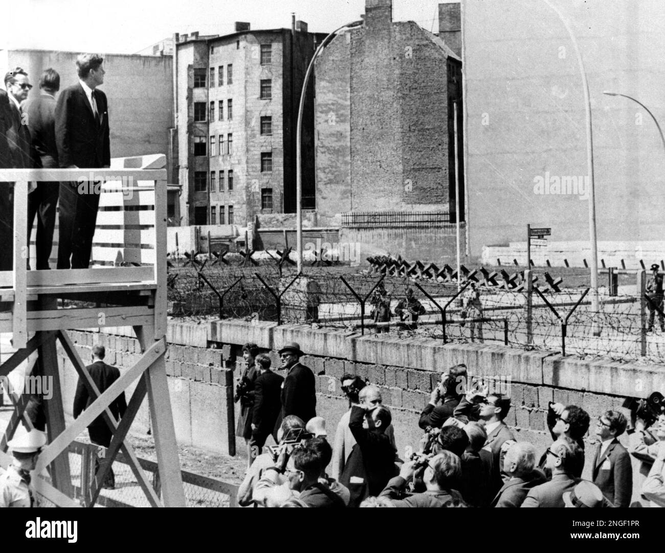 U.S. President John F. Kennedy stands on an observation platform near ...