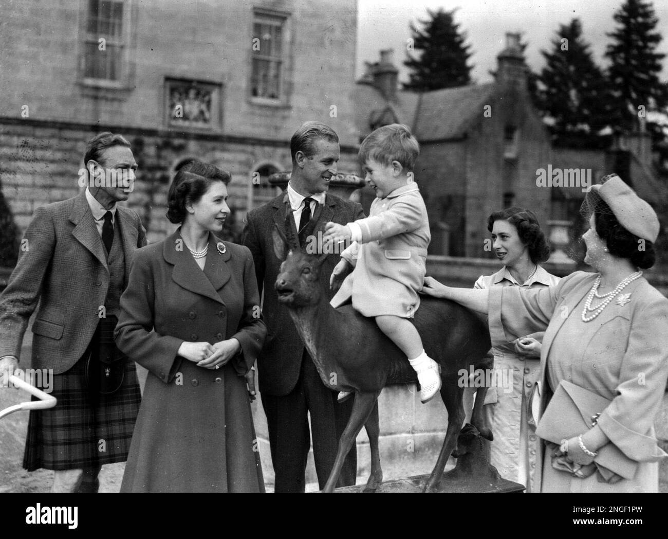 Britain's Prince Charles, watched by, from left, King George VI ...