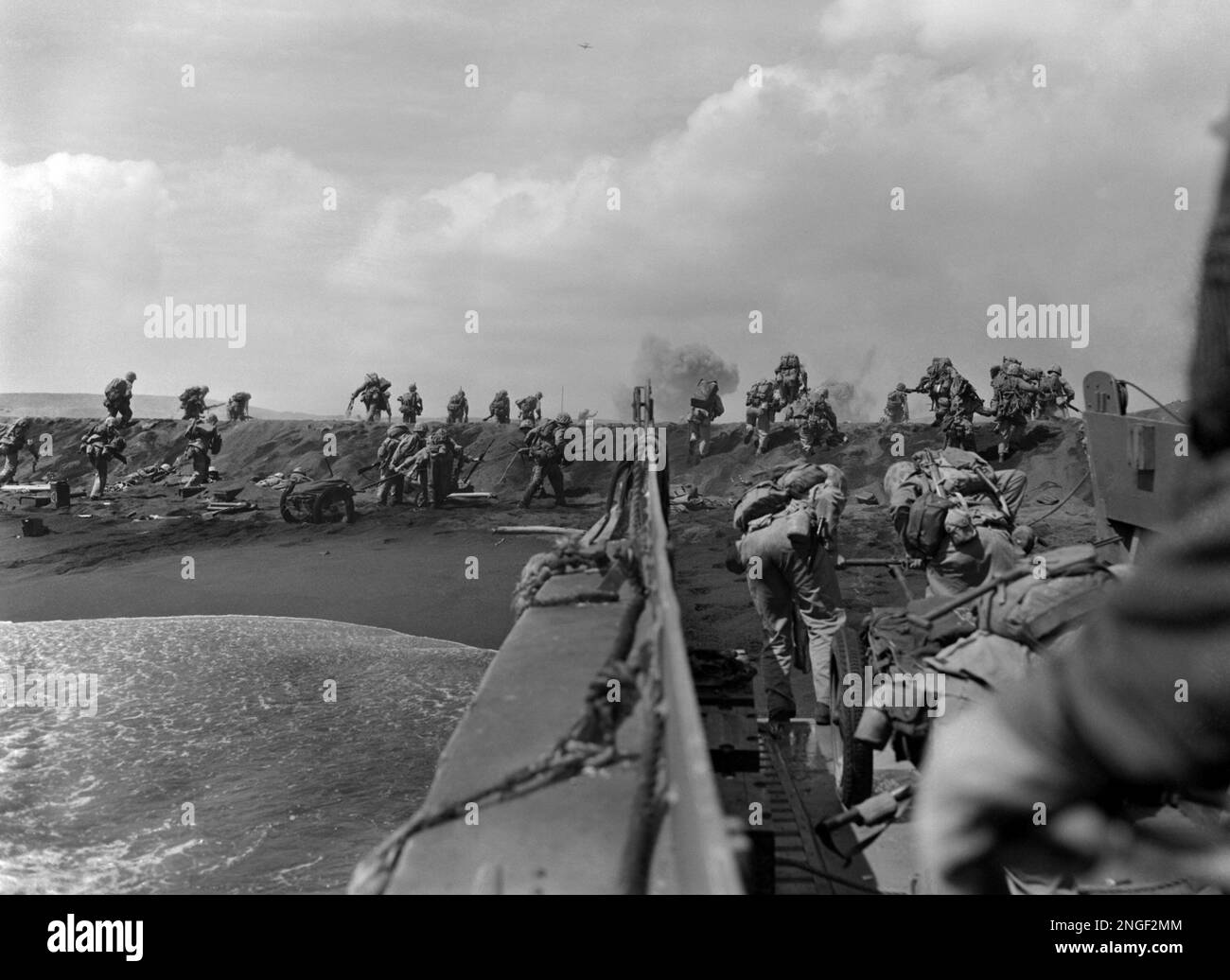 In the Pacific theater of World War II, U.S. Marines hit the beach and ...