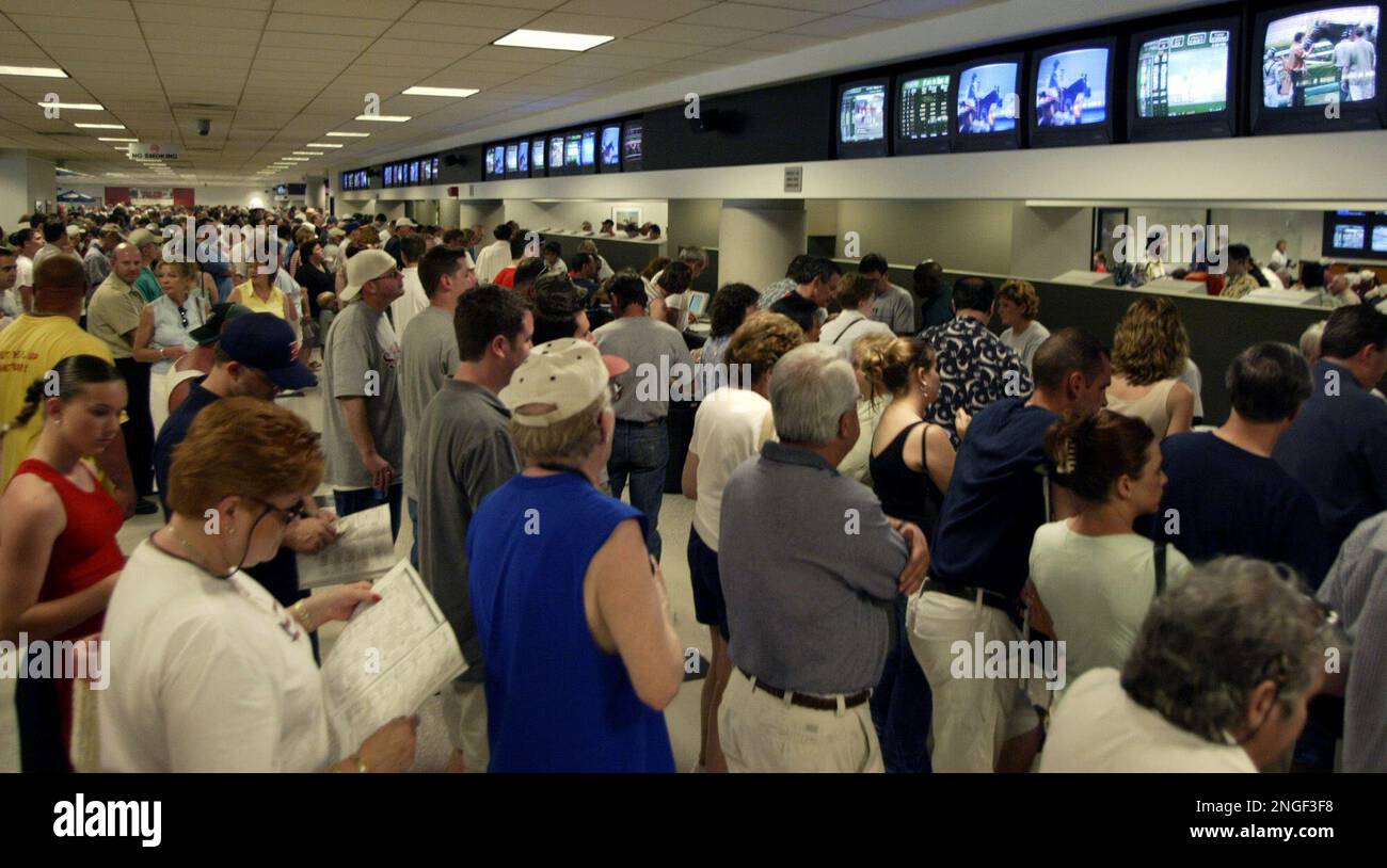 Horse racing fans line up at the betting windows at Philadelphia Park ...