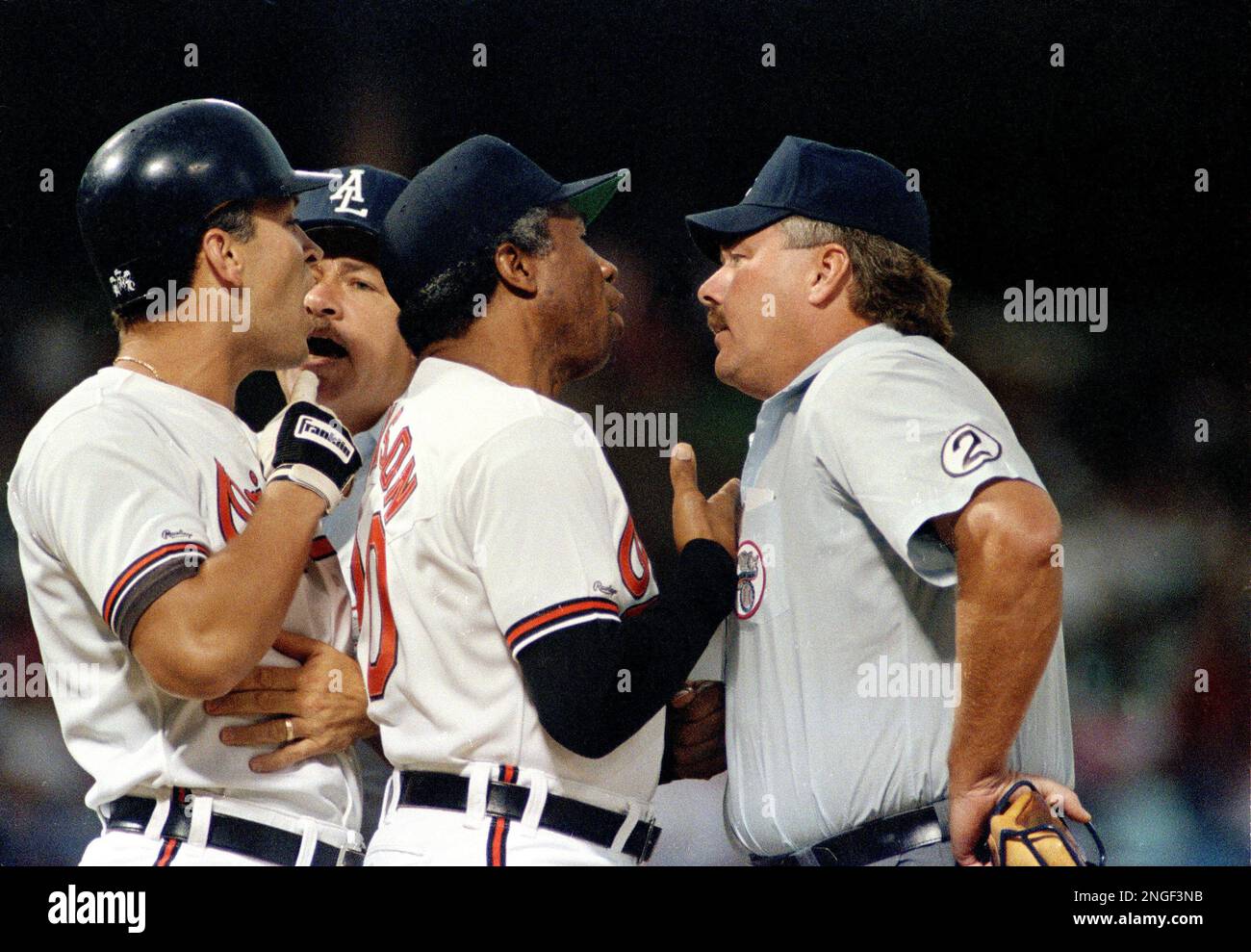 Cal Ripken Jr., of the Baltimore Orioles, left, is restrained by second ...