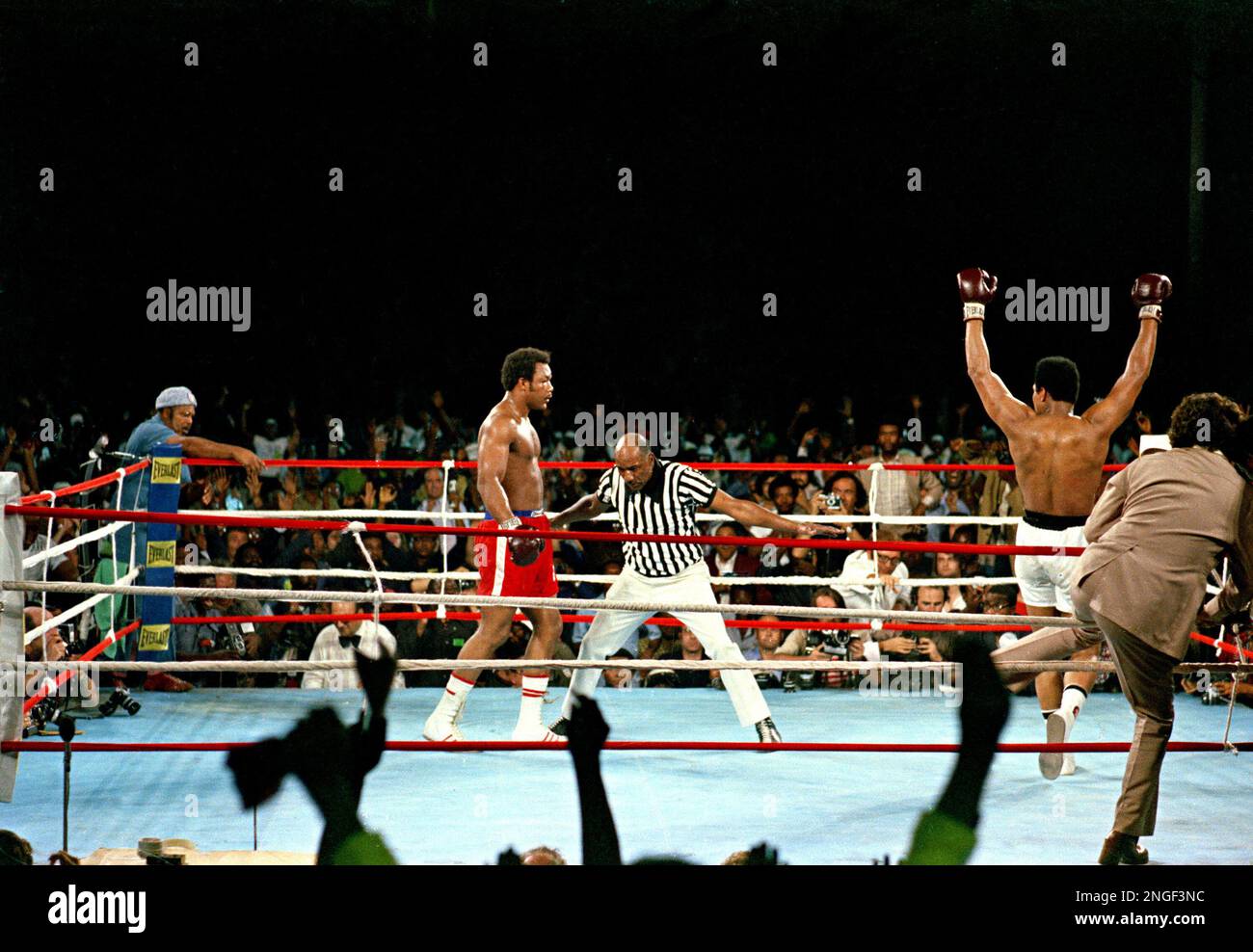 Challenger Muhammad Ali raises his arms in victory after defending ...