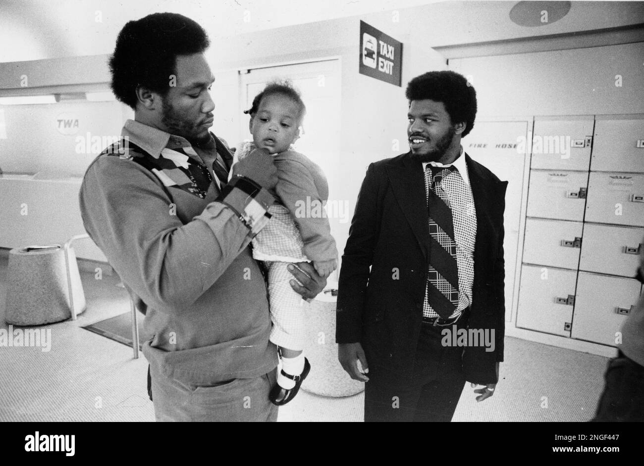 Heavyweight champion George Foreman holds his 17-month-old daughter ...
