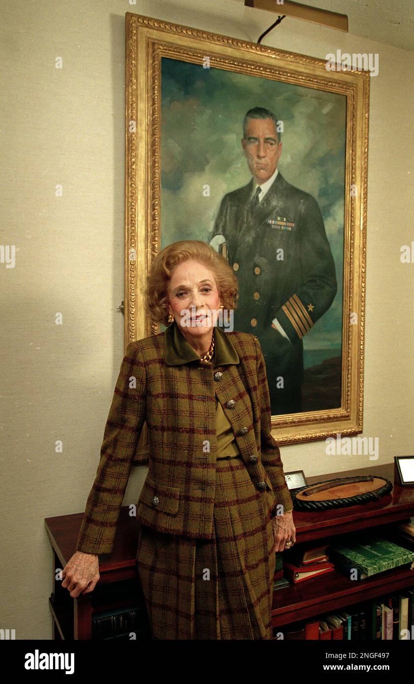 Philanthropist Brooke Astor stands before a portrait of her late ...
