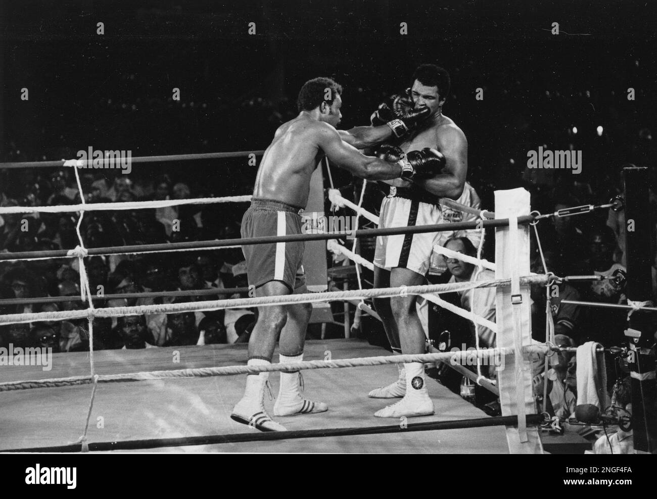 Defending champion George Forman, left, holds Muhammad Ali against the ...