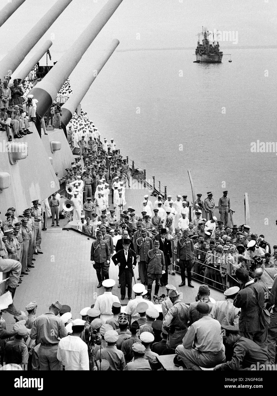 Japanese officials stand in a group facing representatives of the ...