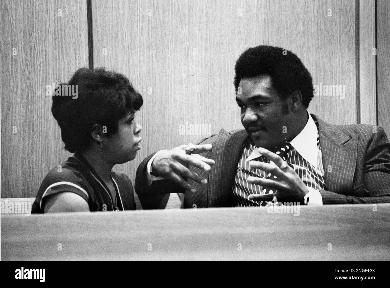 World heavyweight boxing champion George Foreman, right, talks with his ...