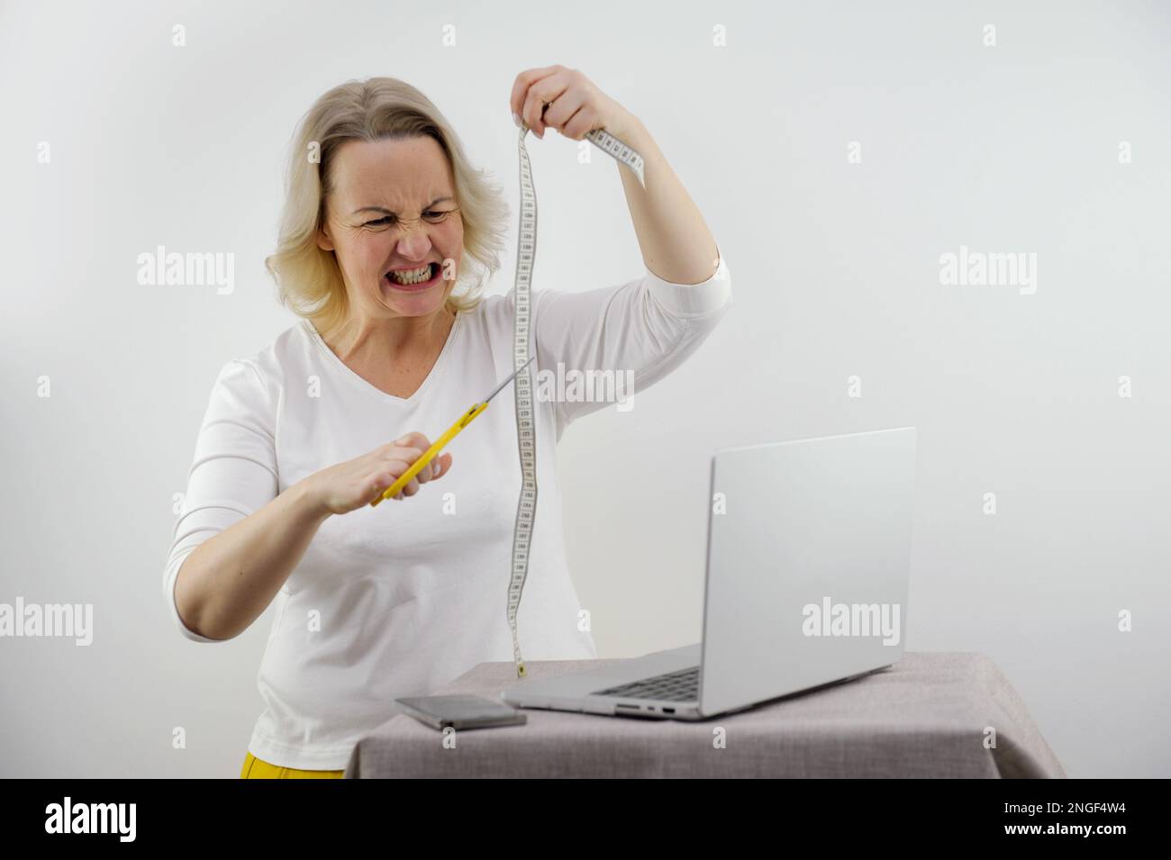 Weight loss fail concept. Scale and depressed, frustrated and sad woman ...