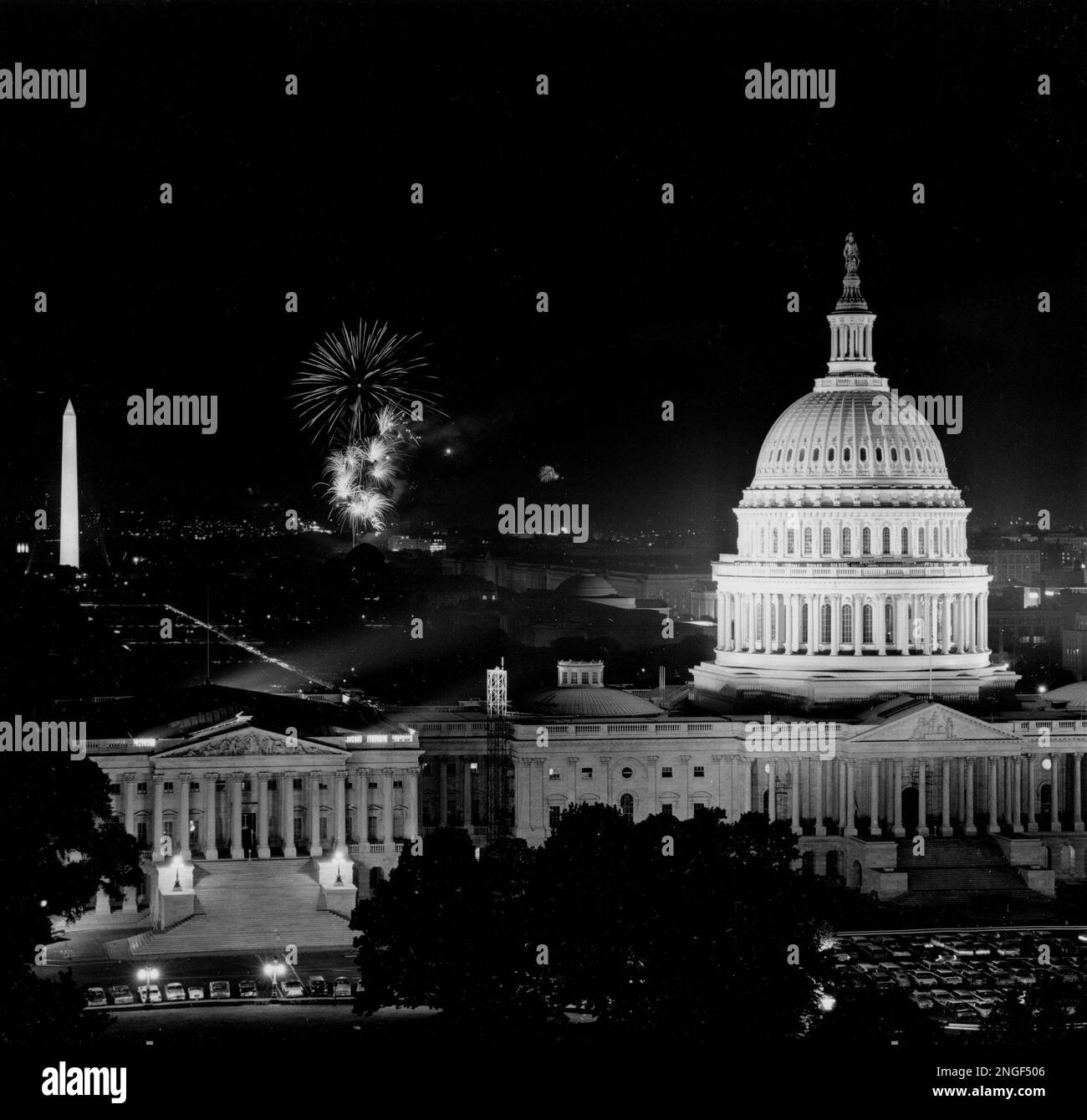 Rockets burst into the sky between Washington Monument, background left ...