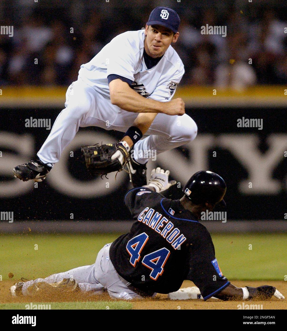 San Diego Padres second baseman Mark Loretta jumps over New York Mets ...