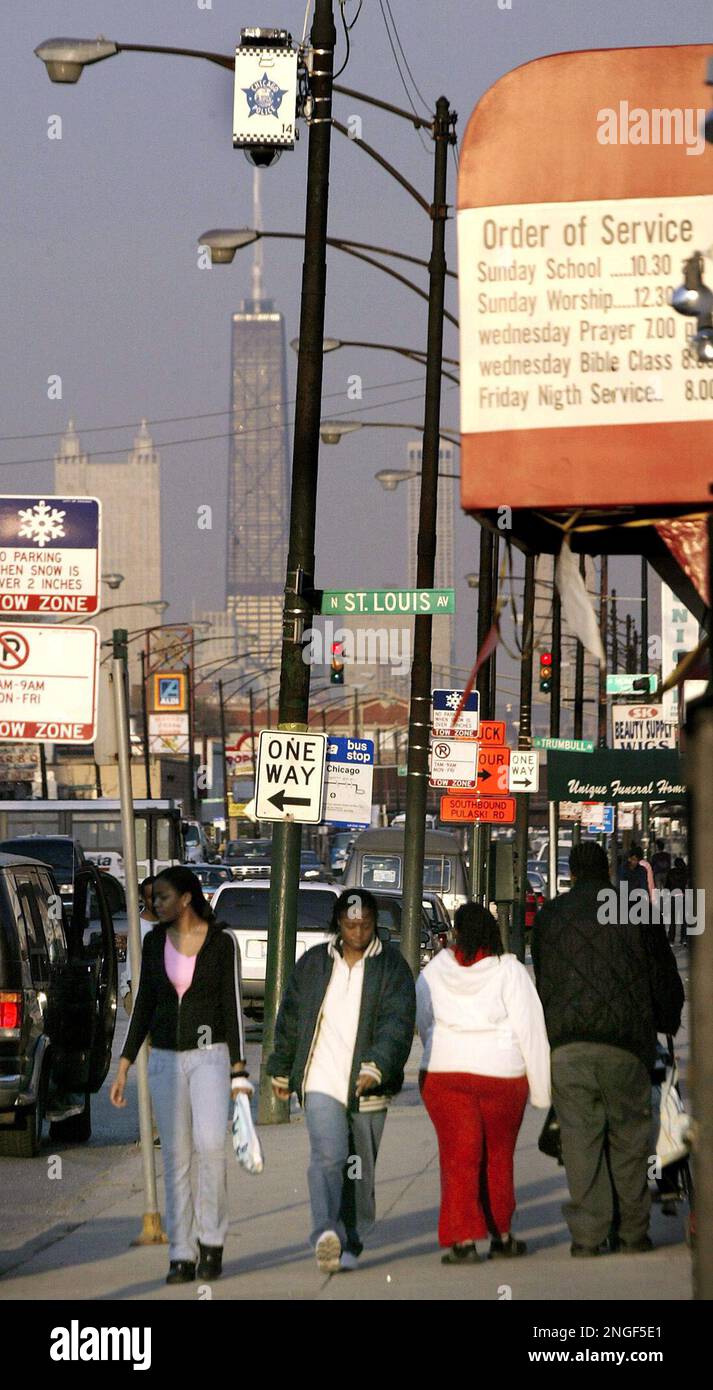 A Chicago Police video camera, above on light pole, monitors Chicago ...