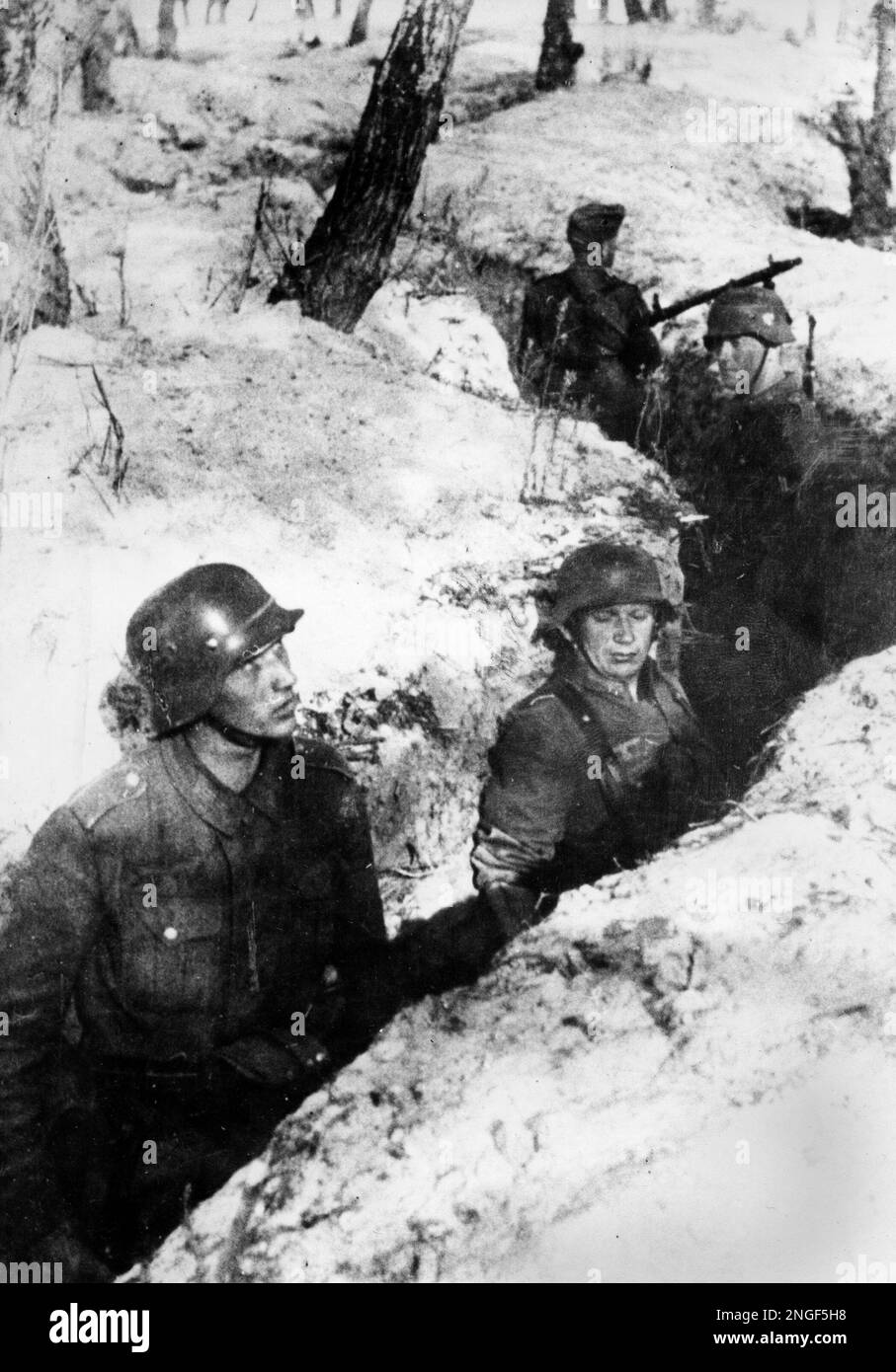 German soldiers, not wearing a greatcoat over their uniform, find cover ...