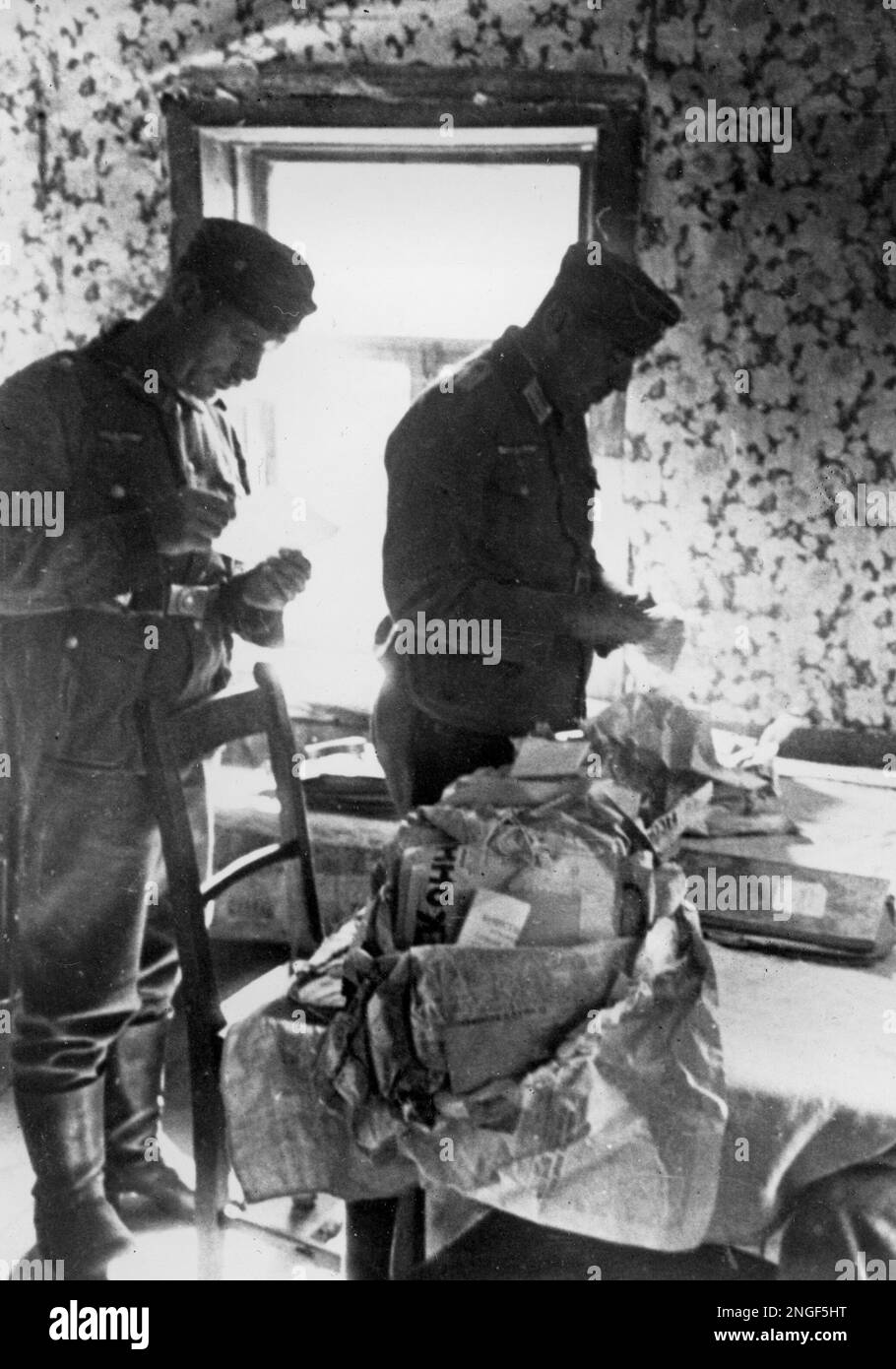 German secret police examine printed material used by Soviet Guerrilla ...