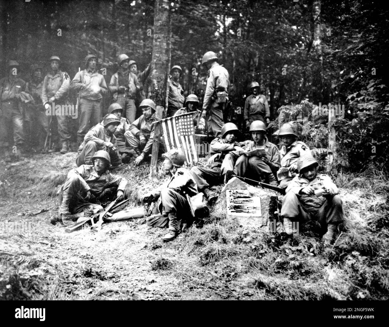 After crossing the border from Belgium, American troops rest in a ...