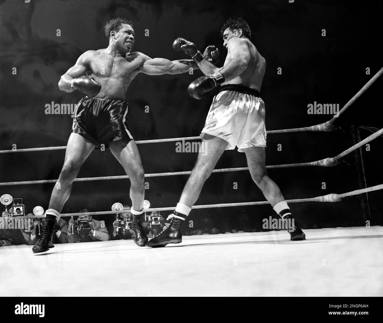 With his mouth wide open, light heavyweight champion Archie Moore, left ...