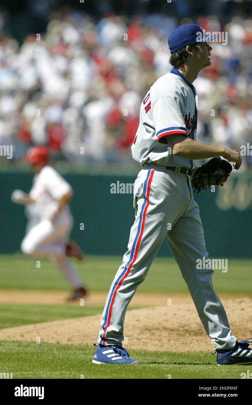 Montreal Expos' John Patterson, right, walks off the mound after giving ...