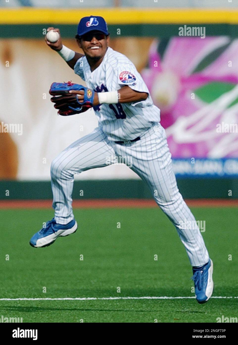 Montreal Expos shortstop Orlando Cabrera throws to first base as ...