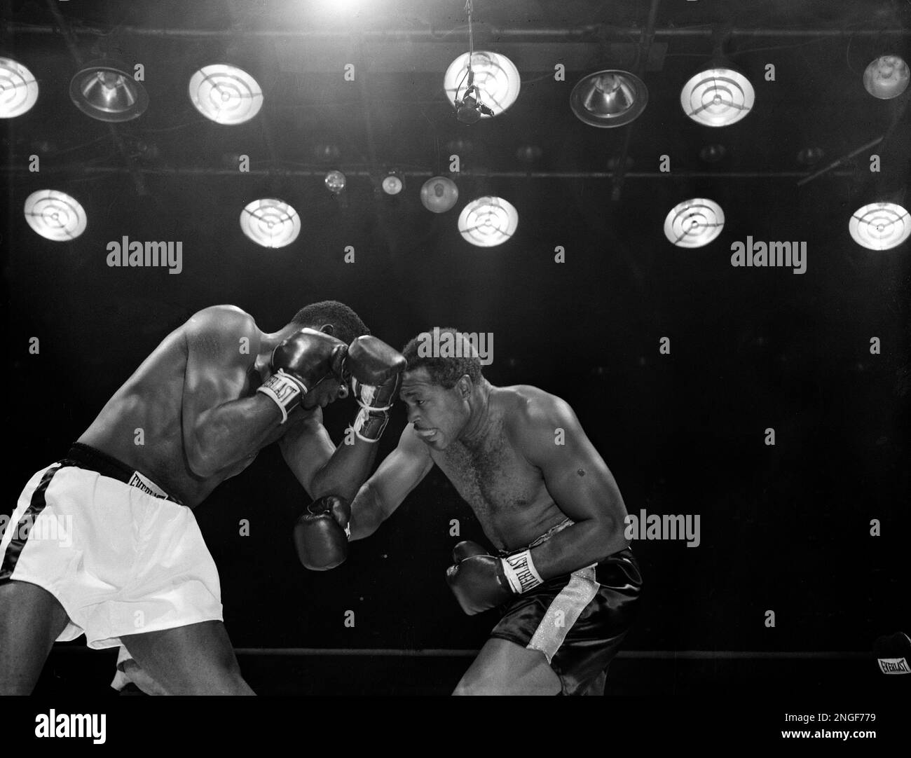Floyd Patterson, left, covers up as Archie Moore moves in close during ...