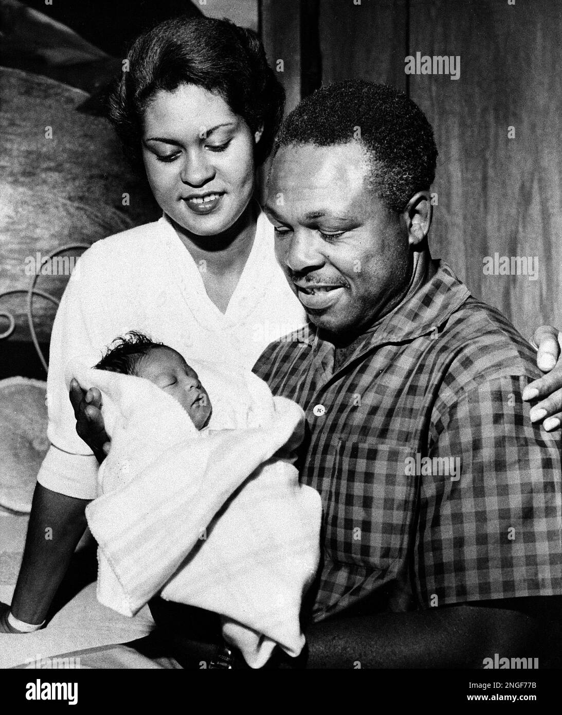 Light heavyweight boxing champion Archie Moore holds is newborn ...