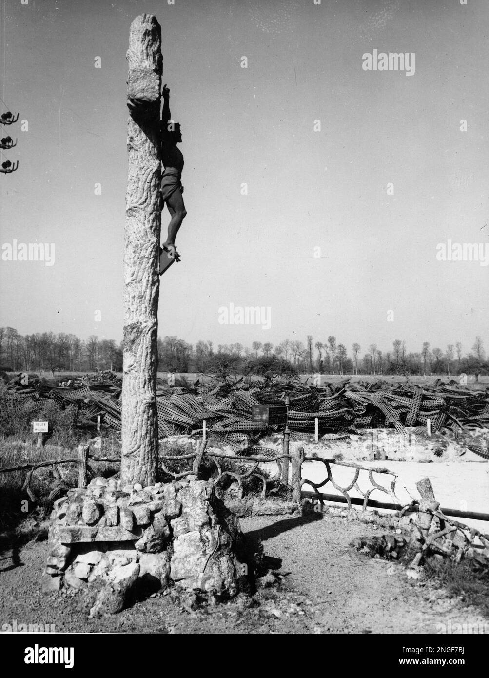 A crucifix stands over a pile of steel treads which had covered the ...