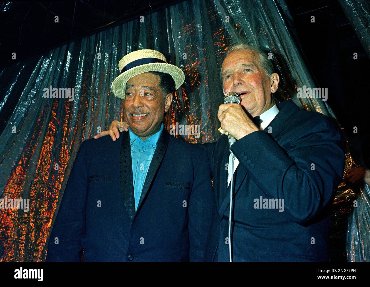 American orchestra leader Duke Ellington wears a straw hat presented by ...
