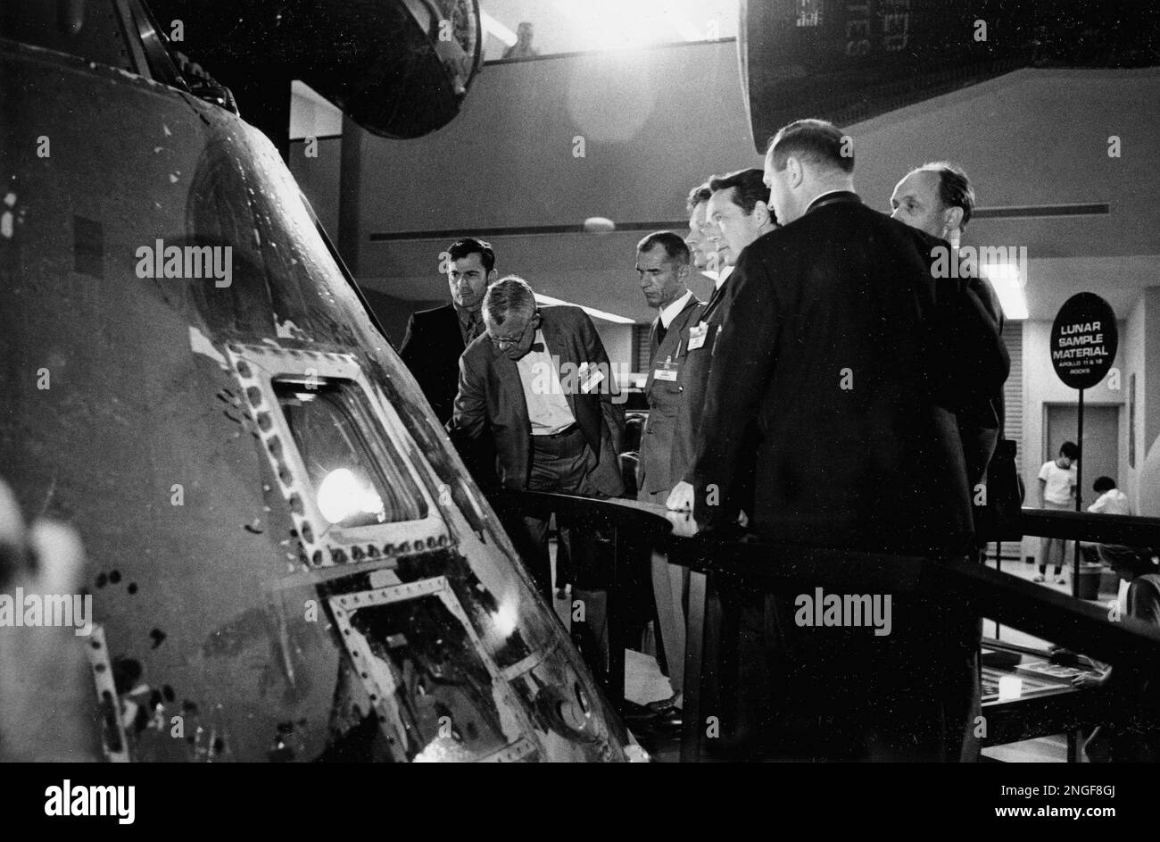 Astronaut John Young, left, shows and explains parts of the Apollo 9 command spacecraft to a ...