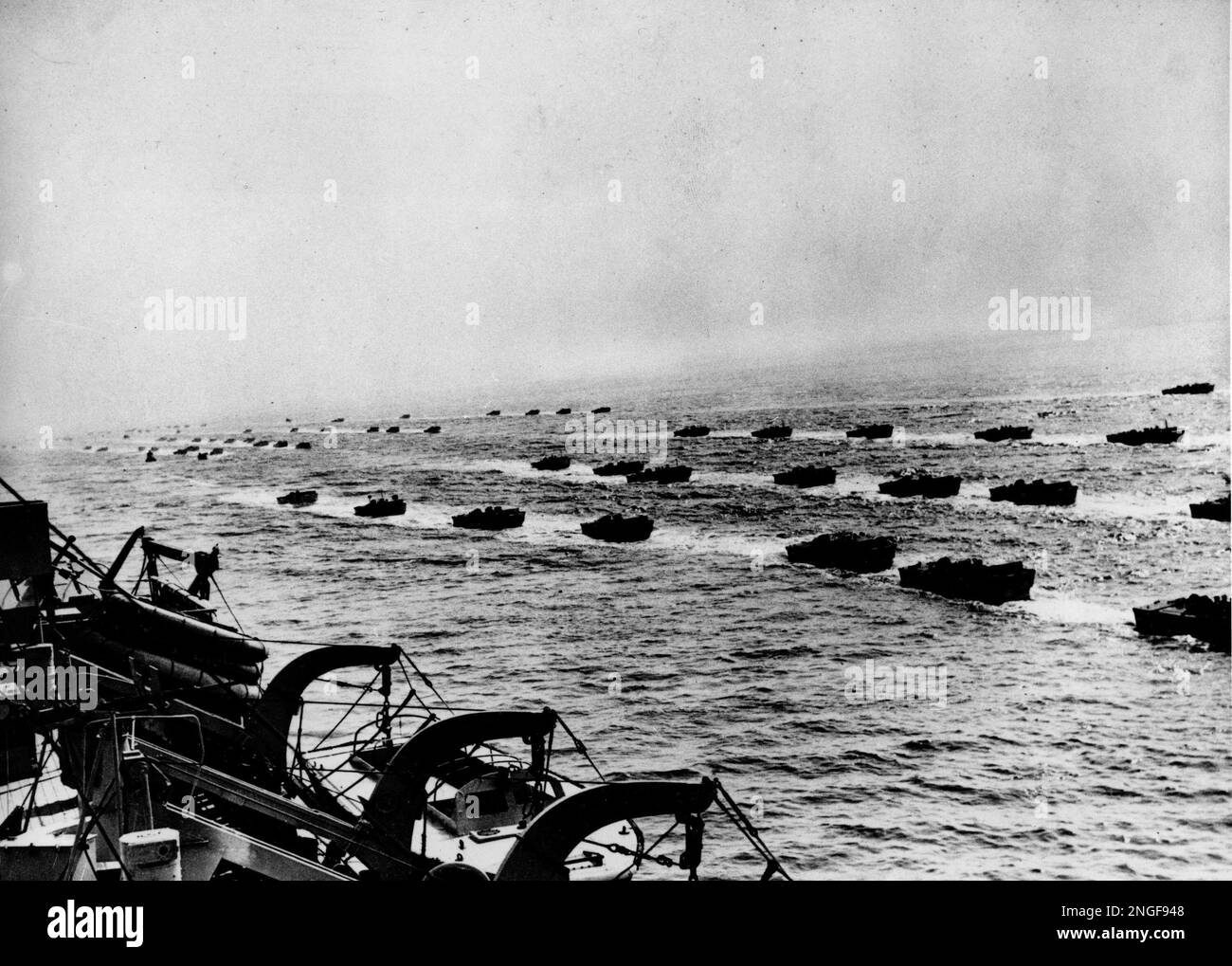 British assault landing craft in mass formation are shown as they move ...