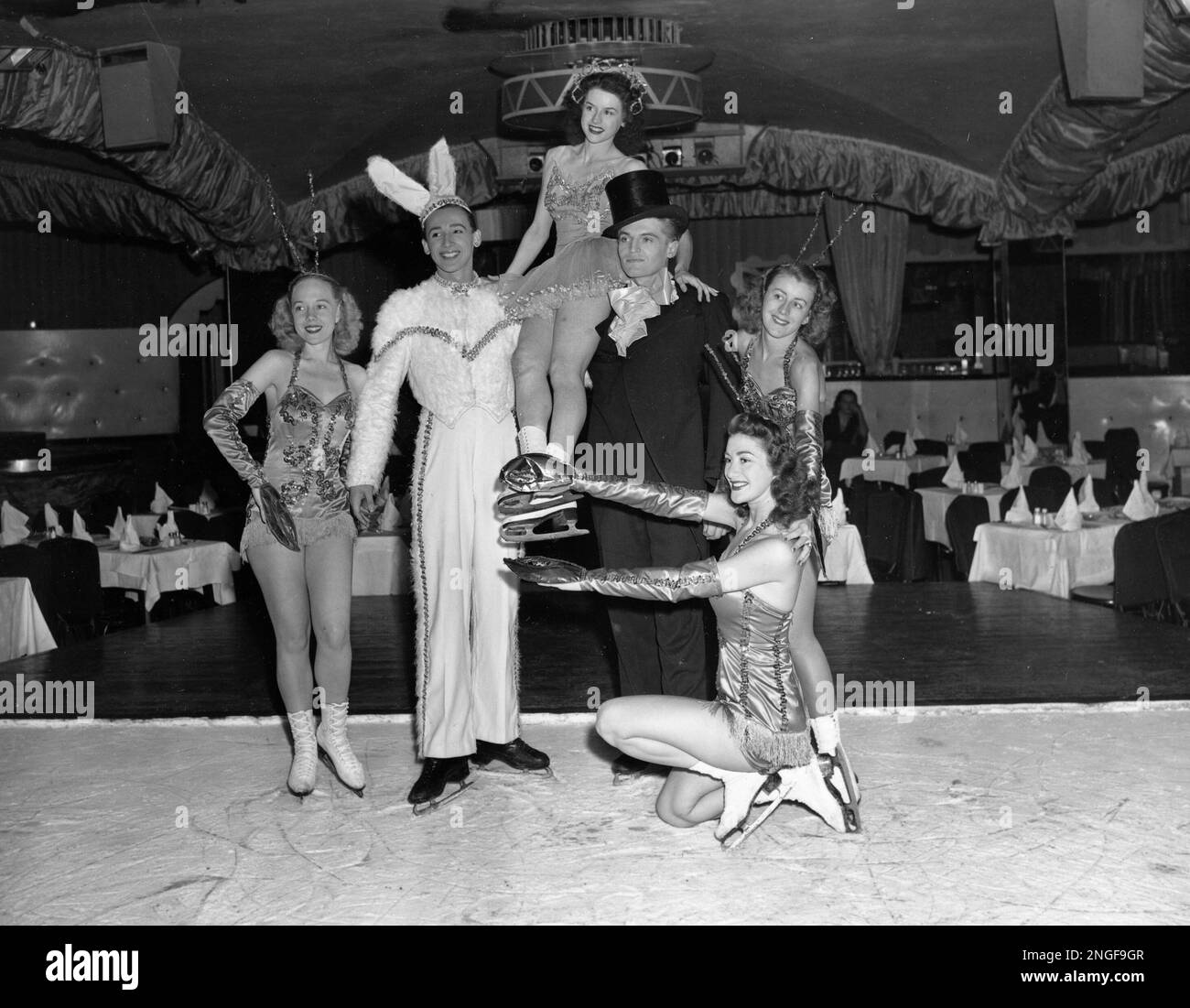 The cast of an adaptation of "Alice In Wonderland" on ice poses on ...