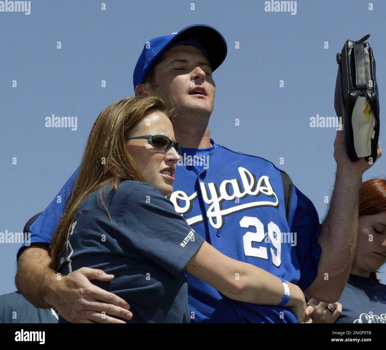 Kansas City Royals first baseman Mike Sweeney holds a Bible as he and ...