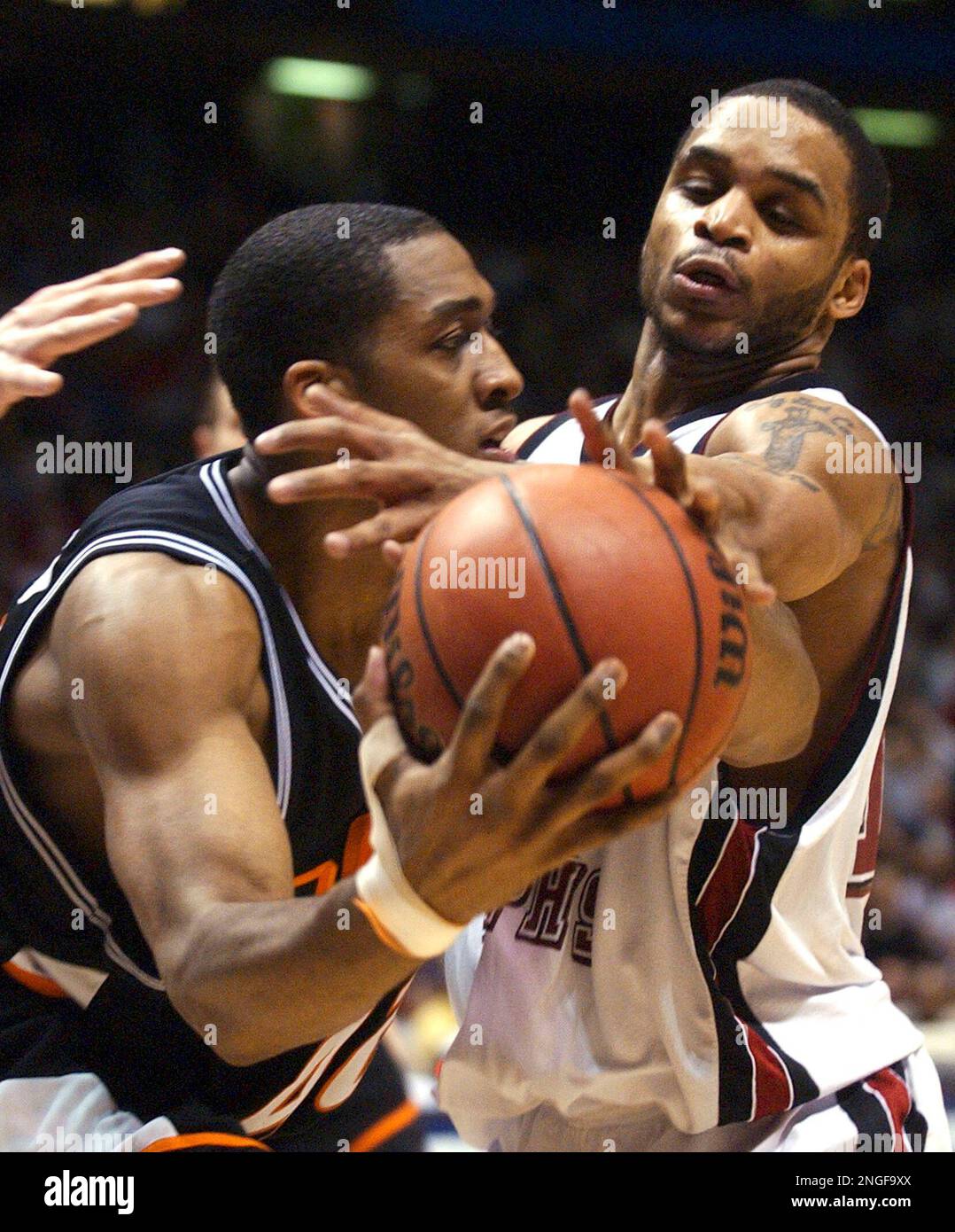 Oklahoma State's Joey Graham, left, looks to pass the ball as Saint ...