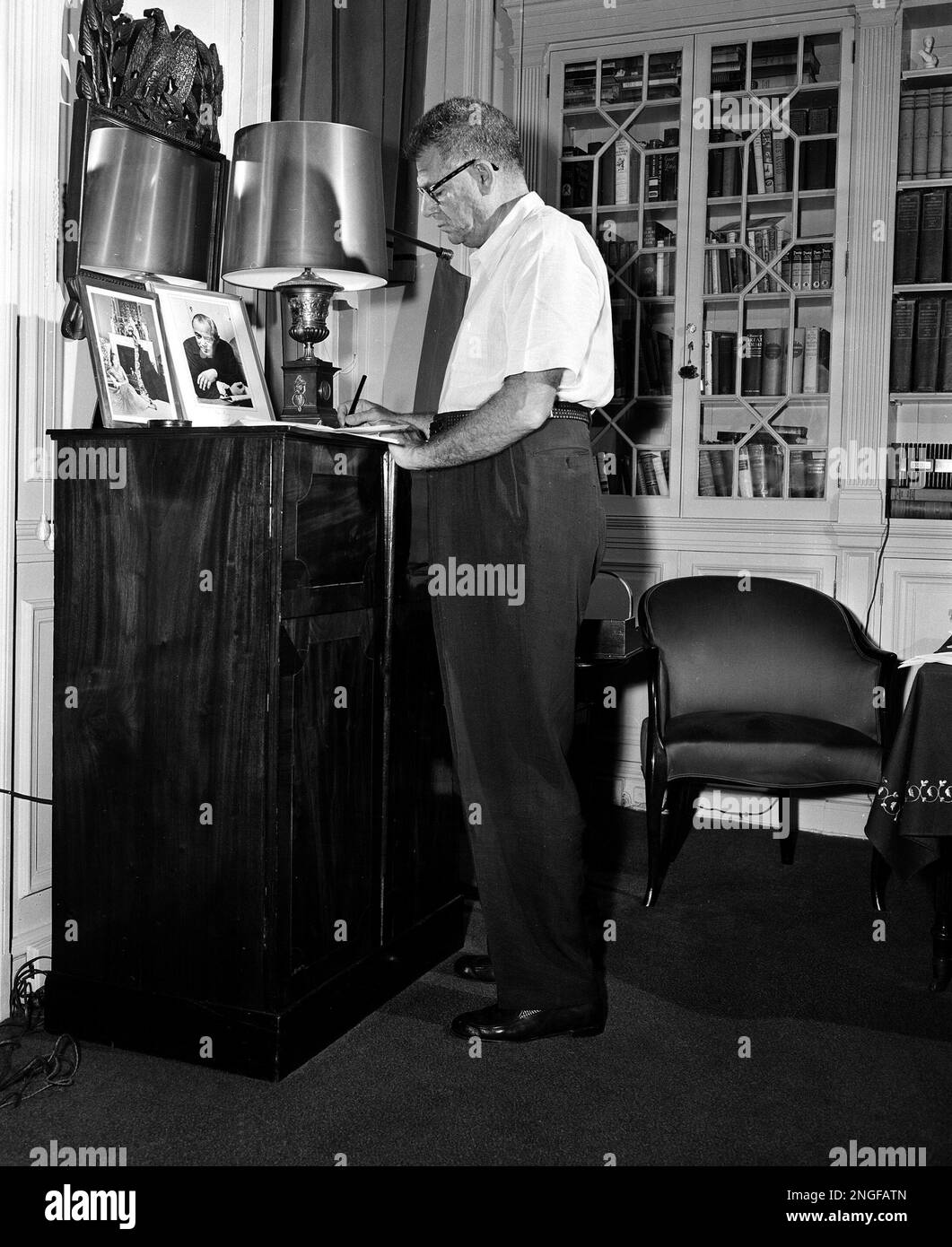 Librettist and theatrical producer Oscar Hammerstein works standing up ...