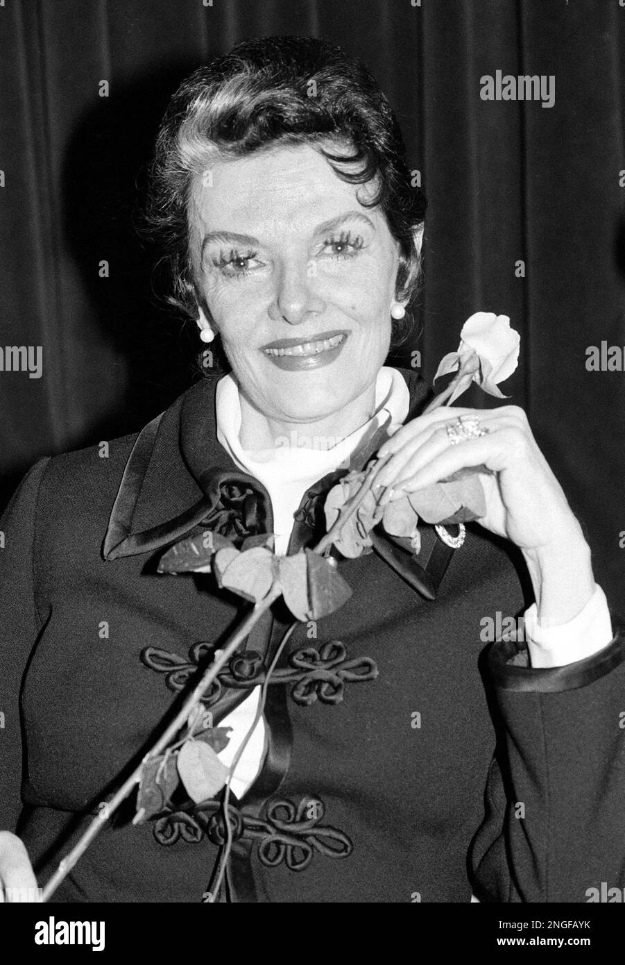 Actress Jane Russell poses with a single rose during a break in taping ...