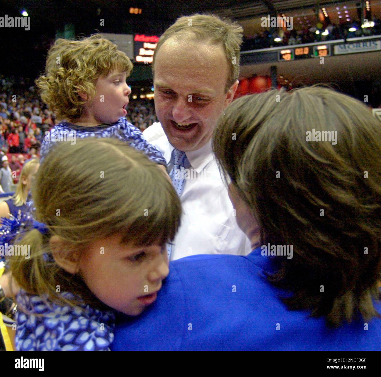 Xavier coach Thad Matta, center, stands on the court with his wife ...