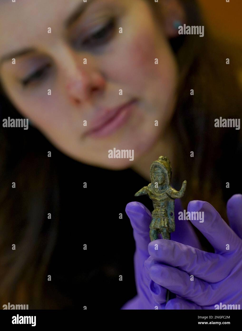 Curatorial and Learning Officer Sarah Harvey, places the Birrus ...