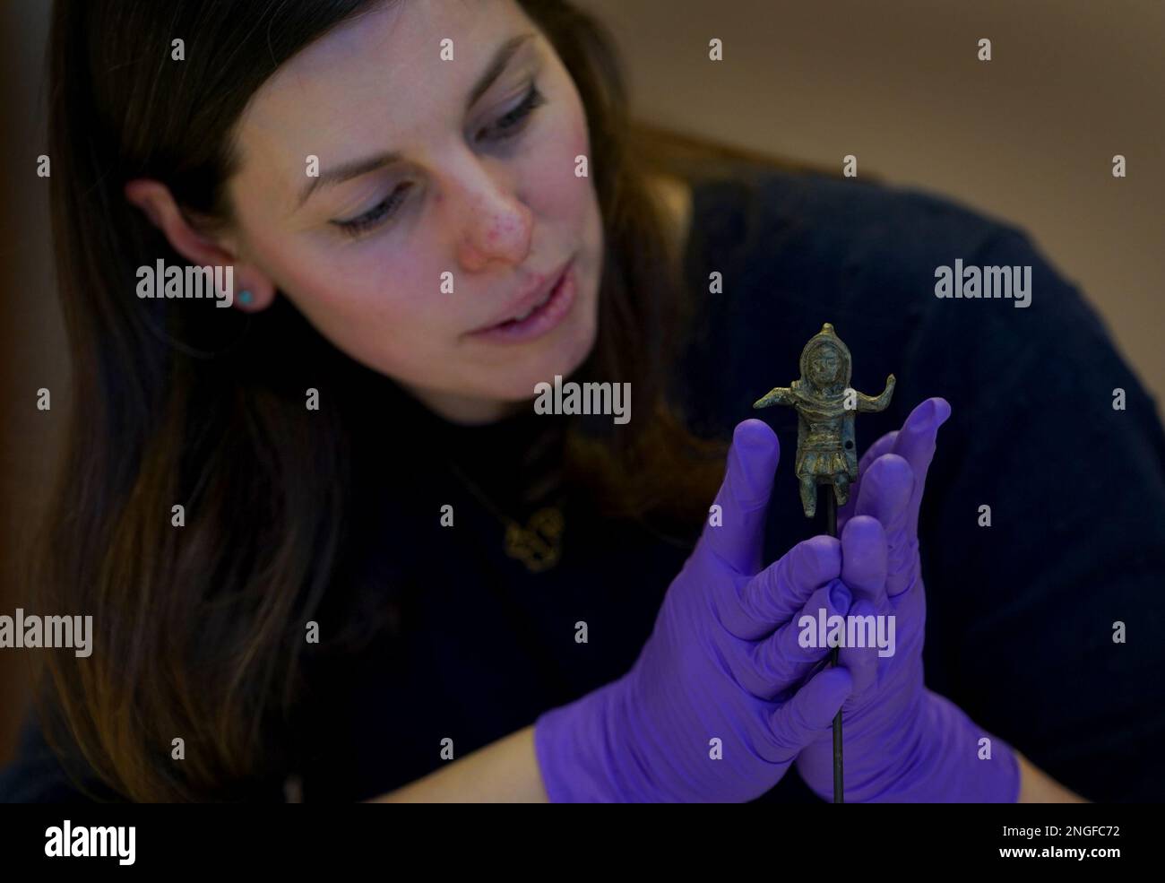 Curatorial and Learning Officer Sarah Harvey, places the Birrus ...