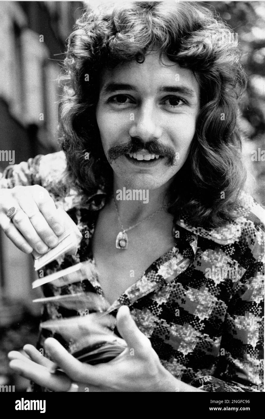 Canadian magician Doug Henning shuffles a deck of cards in New York ...