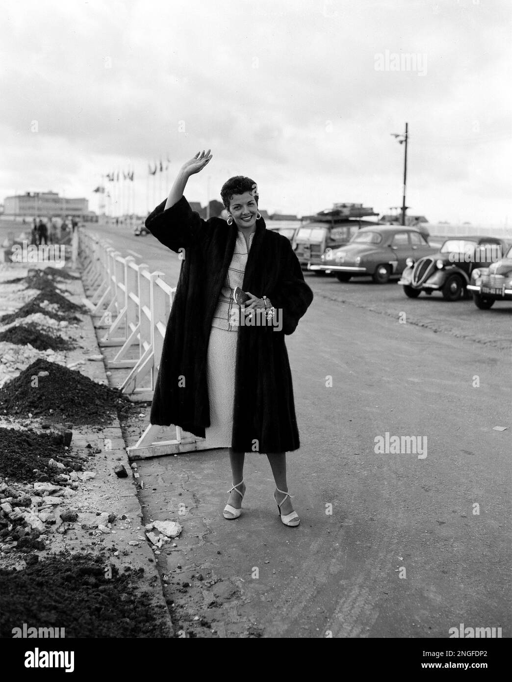 American actress Jane Russell waves to fans and journalists as she ...