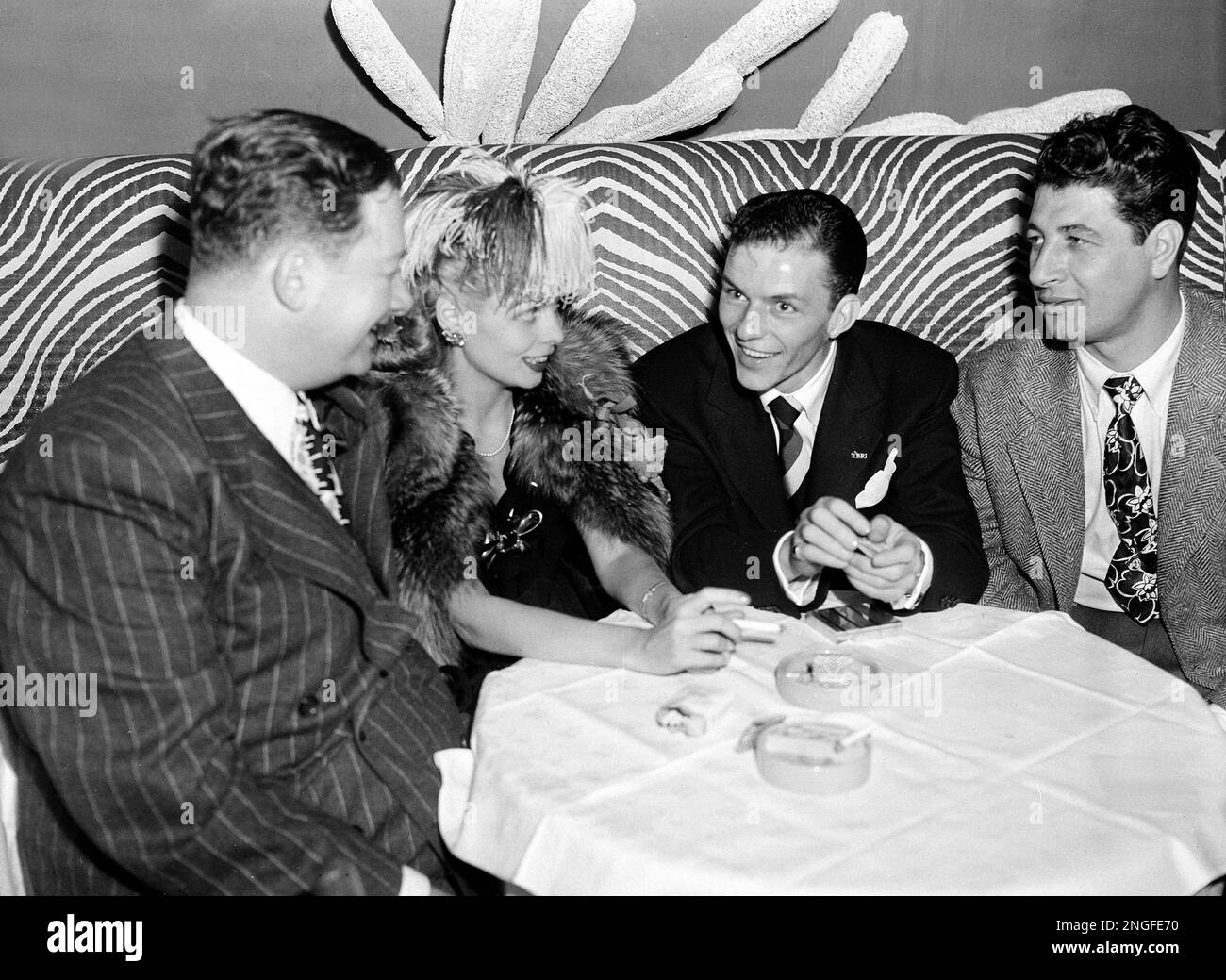 Restaurateur Toots Shor, left, his wife are shown with singer-actor ...