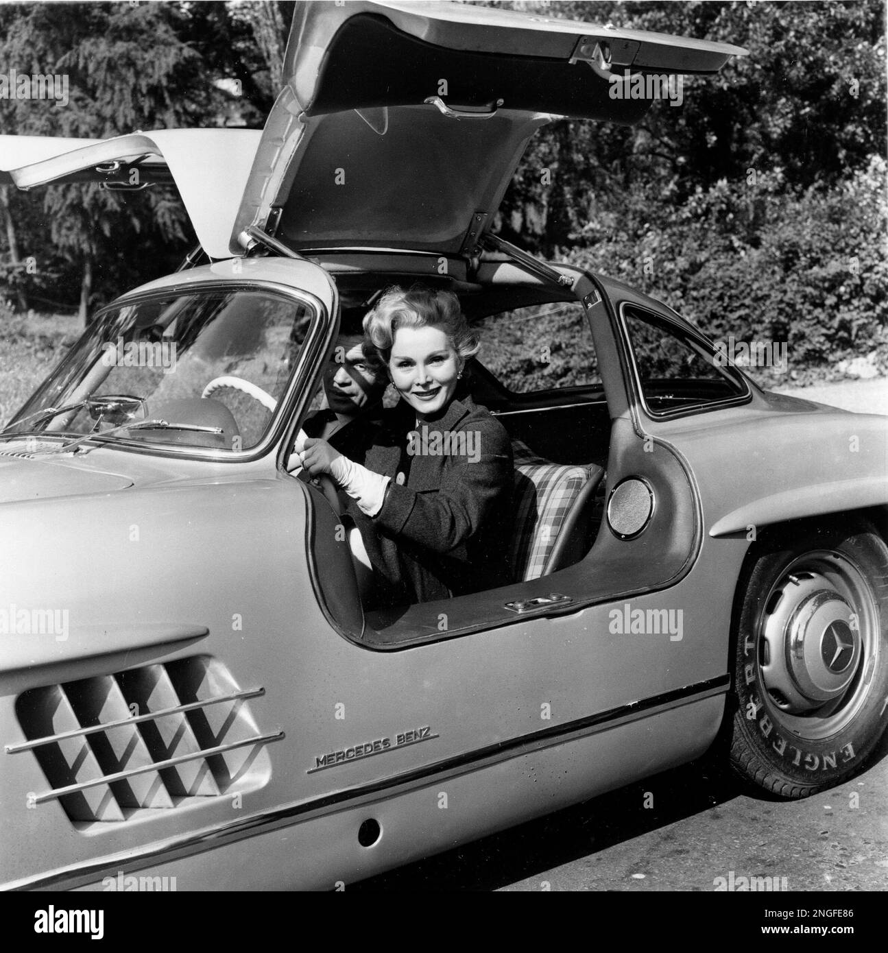 American actress Zsa Zsa Gabor sits at the wheel of a Mercedes Benz 300 ...