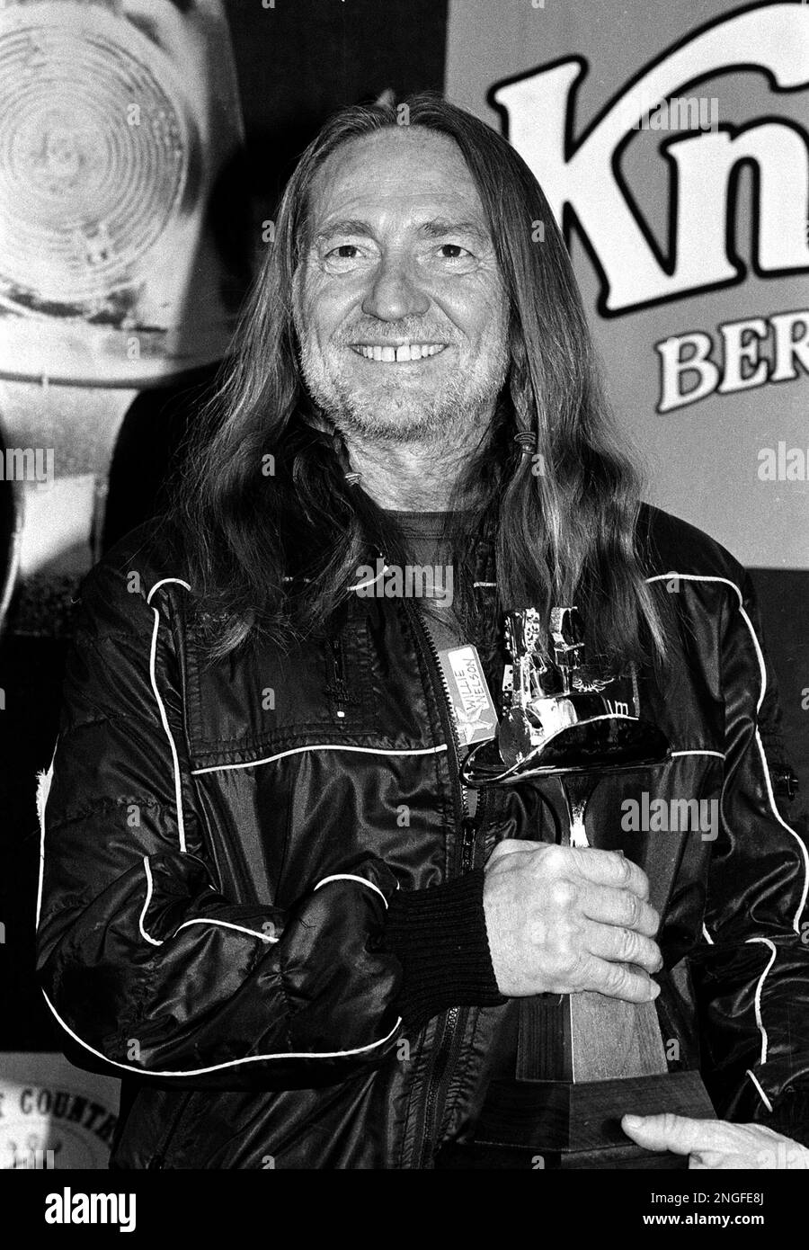 Country music singer Willie Nelson poses with one of two awards he won ...