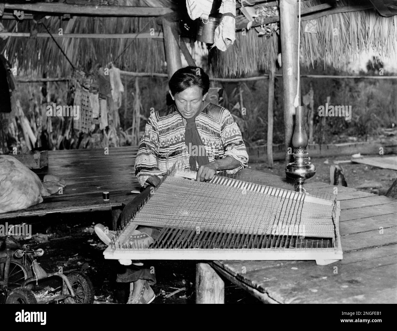Sitting on the raised floor of an open-sided house in the Florida ...