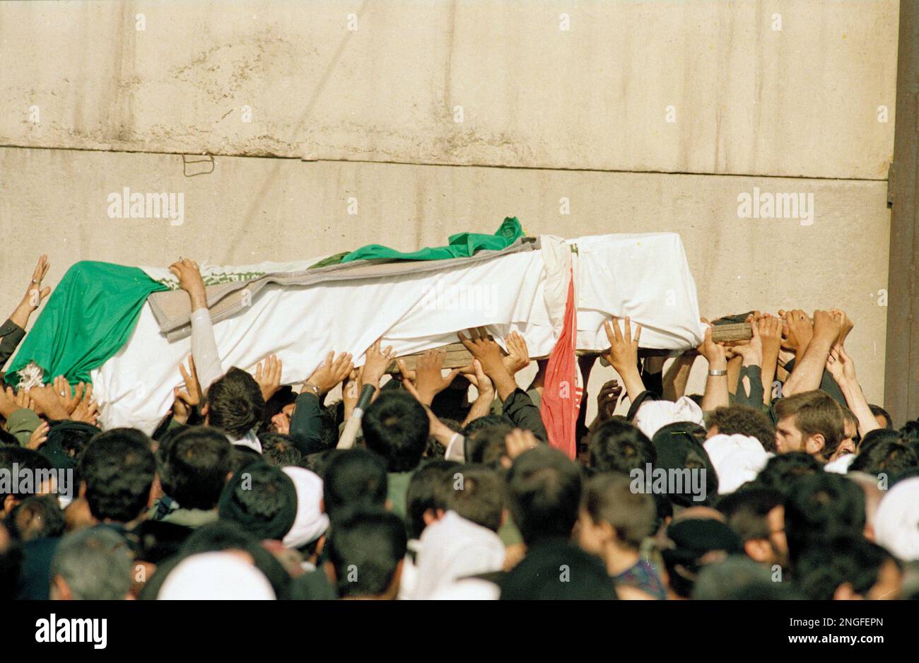 Mourners lift up the bier with the body of late Ayatollah Khomeini ...