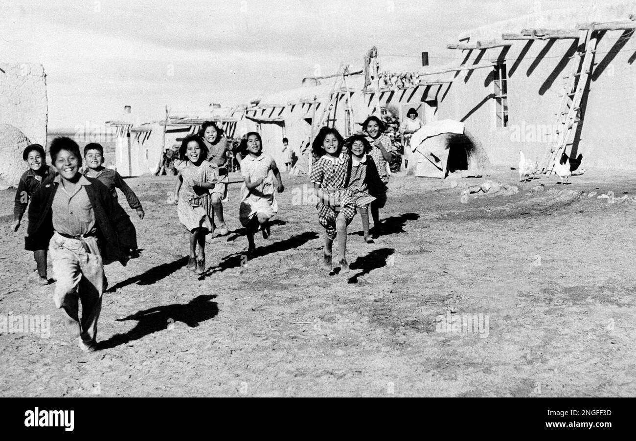 Boys and girls of the Santa Ana Pueblo run together at the grounds of ...